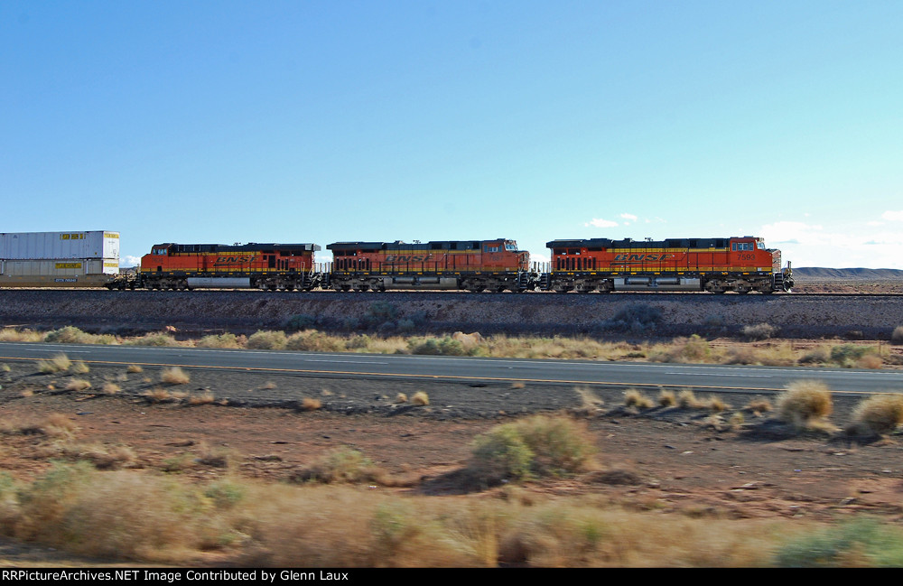BNSF 7593, 0887, 7636 lead a stack train west